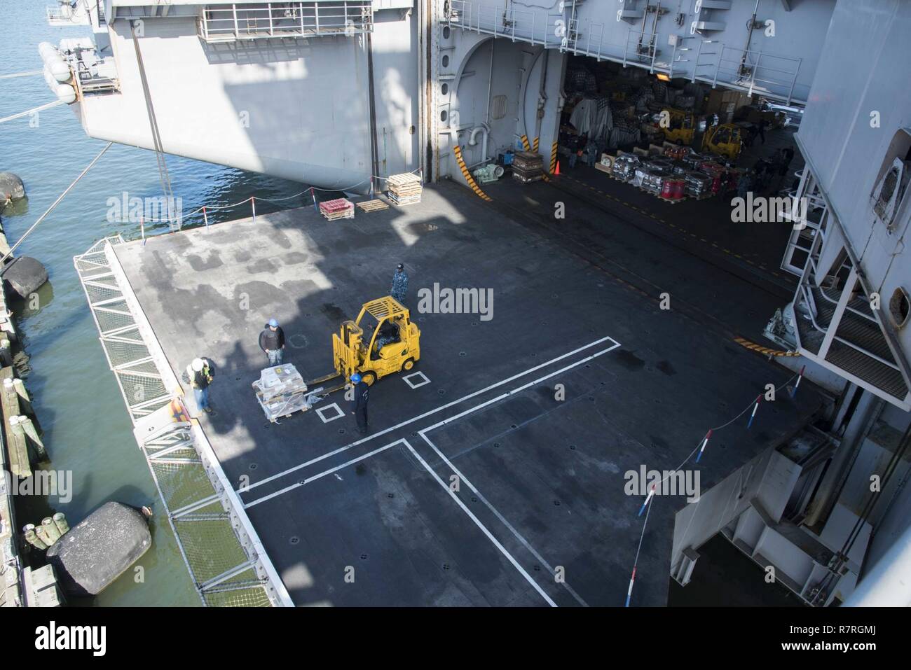 NORFOLK, Va. (March 29, 2017) Sailors transport supplies on an aircraft ...