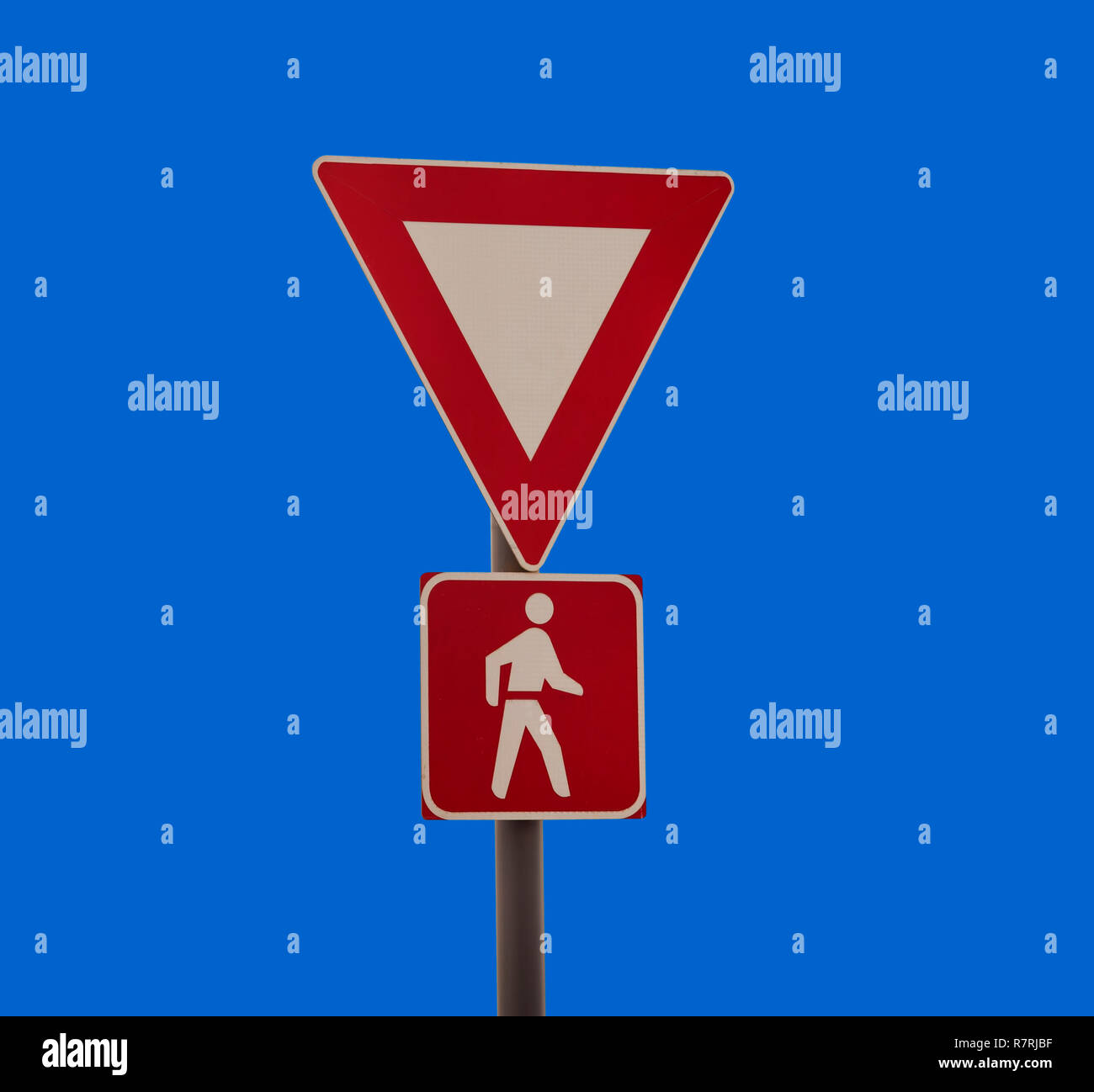 give way traffic sign isolated on blue sky Stock Photo - Alamy