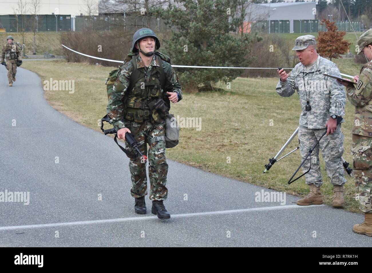 A Macedonian soldier crosses the finish line after a 12 mile ruck march ...