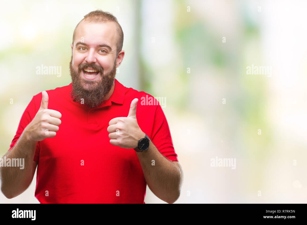Young caucasian hipster man wearing red shirt over isolated background ...