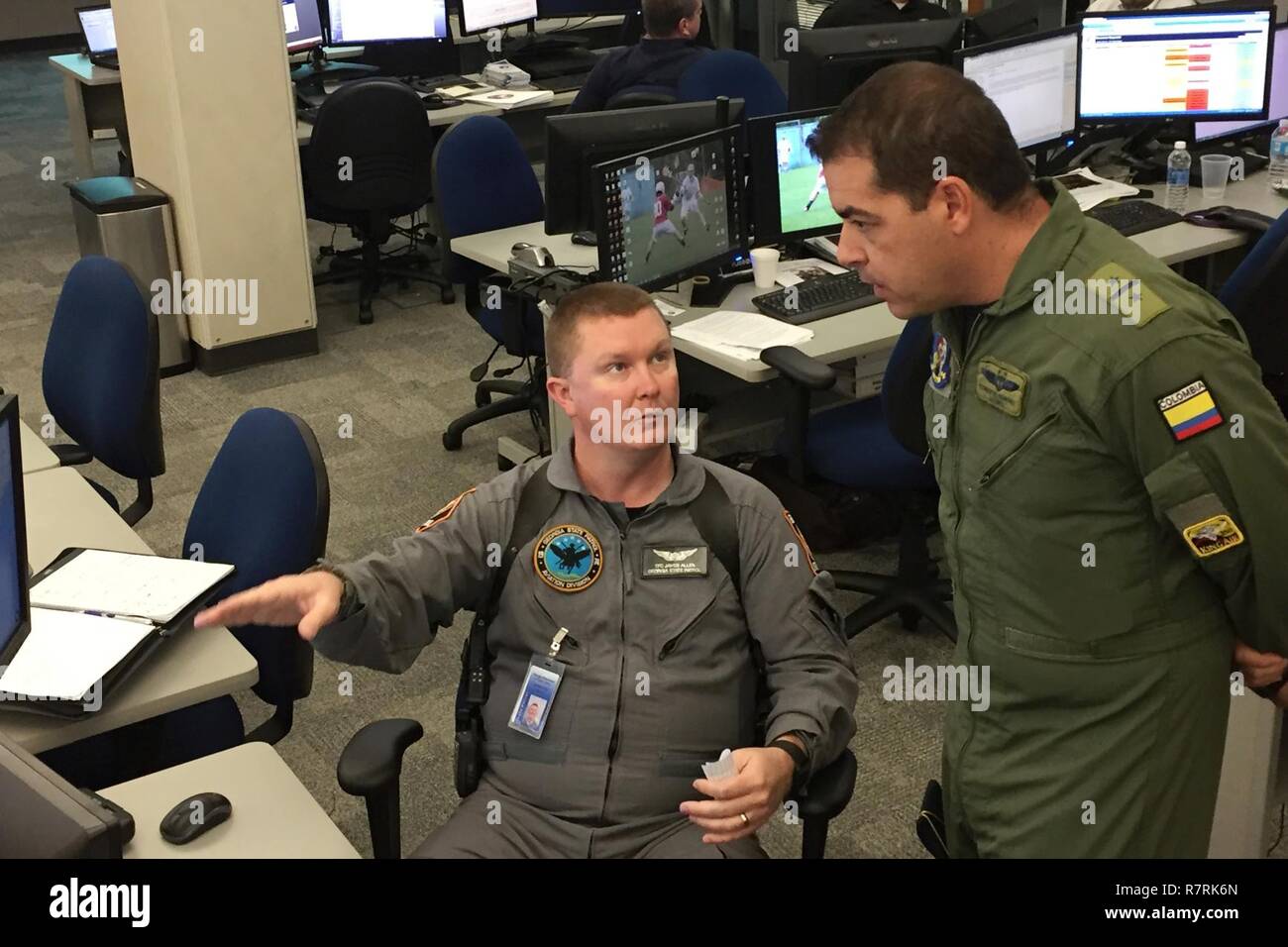 Colombian air force Lt. Col. Ernesto Gomez (right) discusses air ...