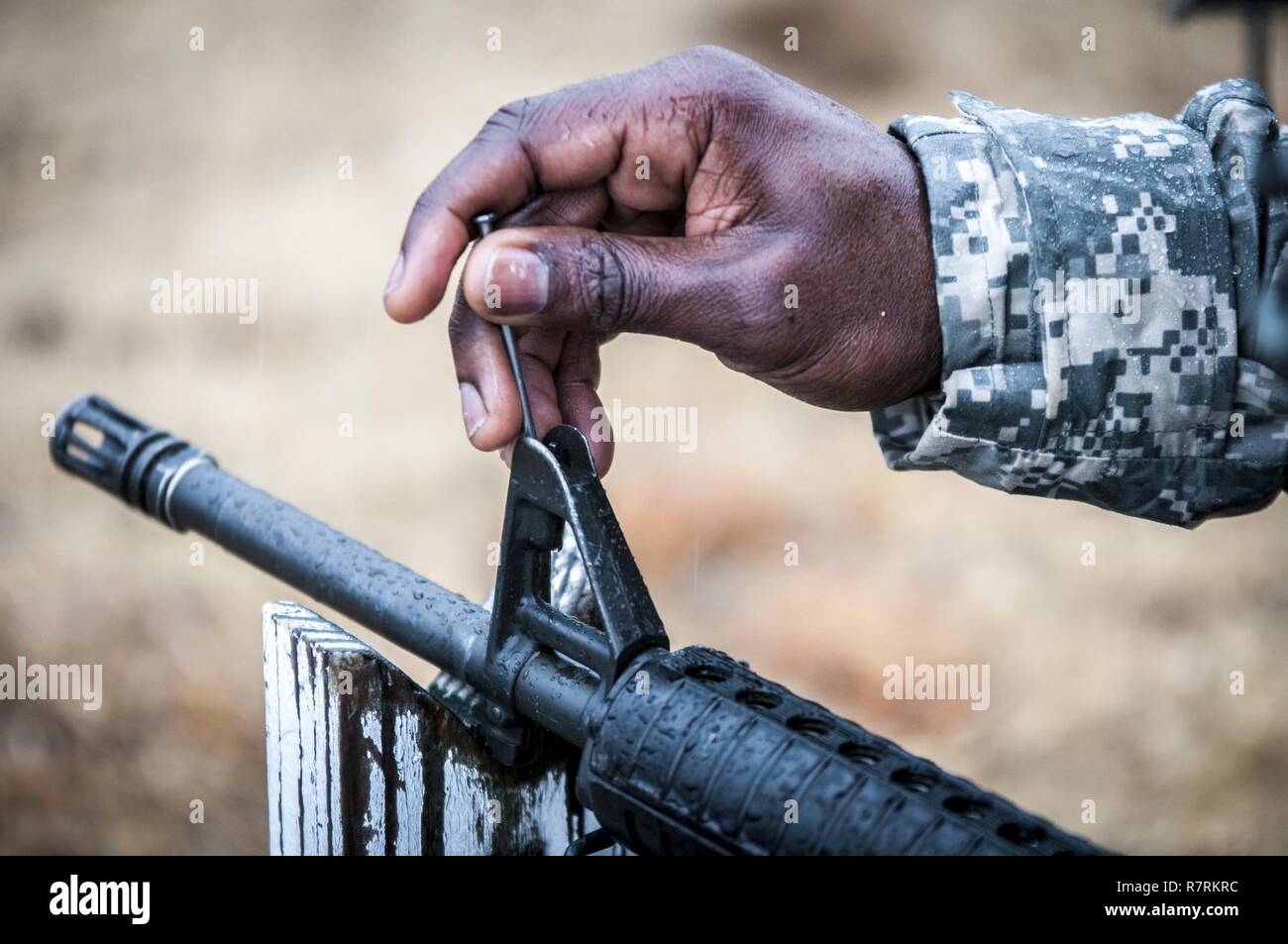 FORT DEVENS, Massachusetts – A soldier adjusts his M16-A2’s front sight ...