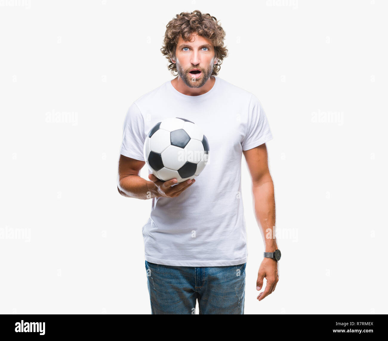 Handsome hispanic man model holding soccer football ball over isolated ...