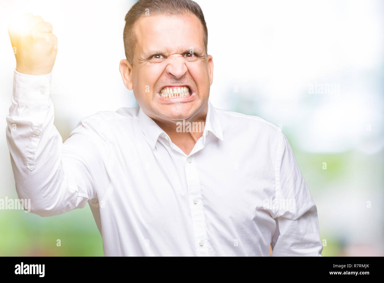 Middle age arab elegant man over isolated background angry and mad ...