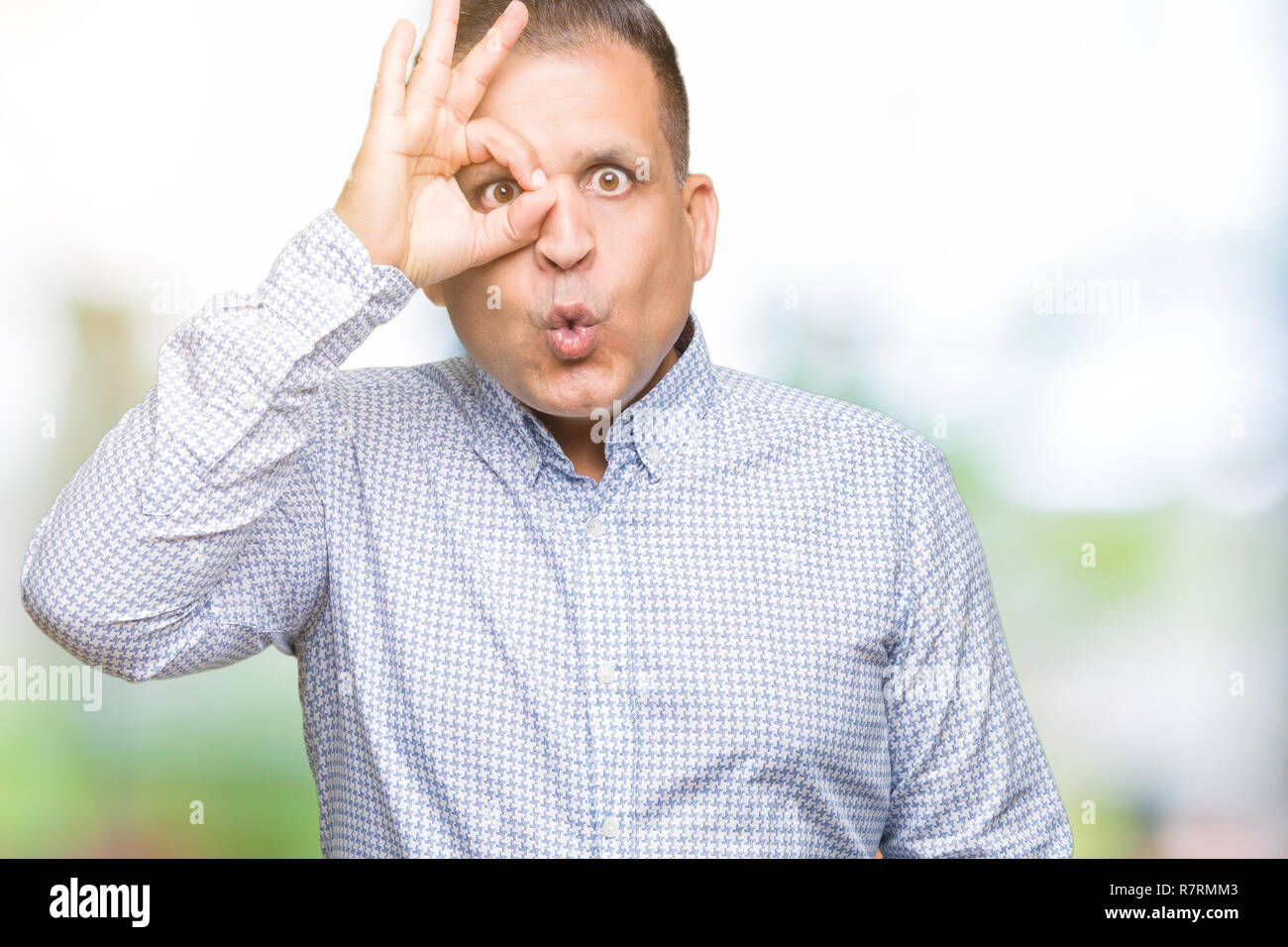 Middle age arab business man over isolated background doing ok gesture ...