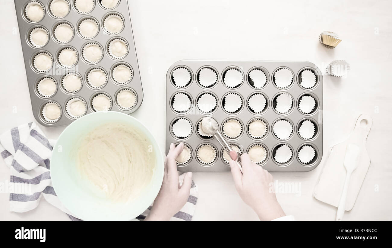 Flat lay. Scooping vanilla cupcake batter into cupcake liners Stock ...