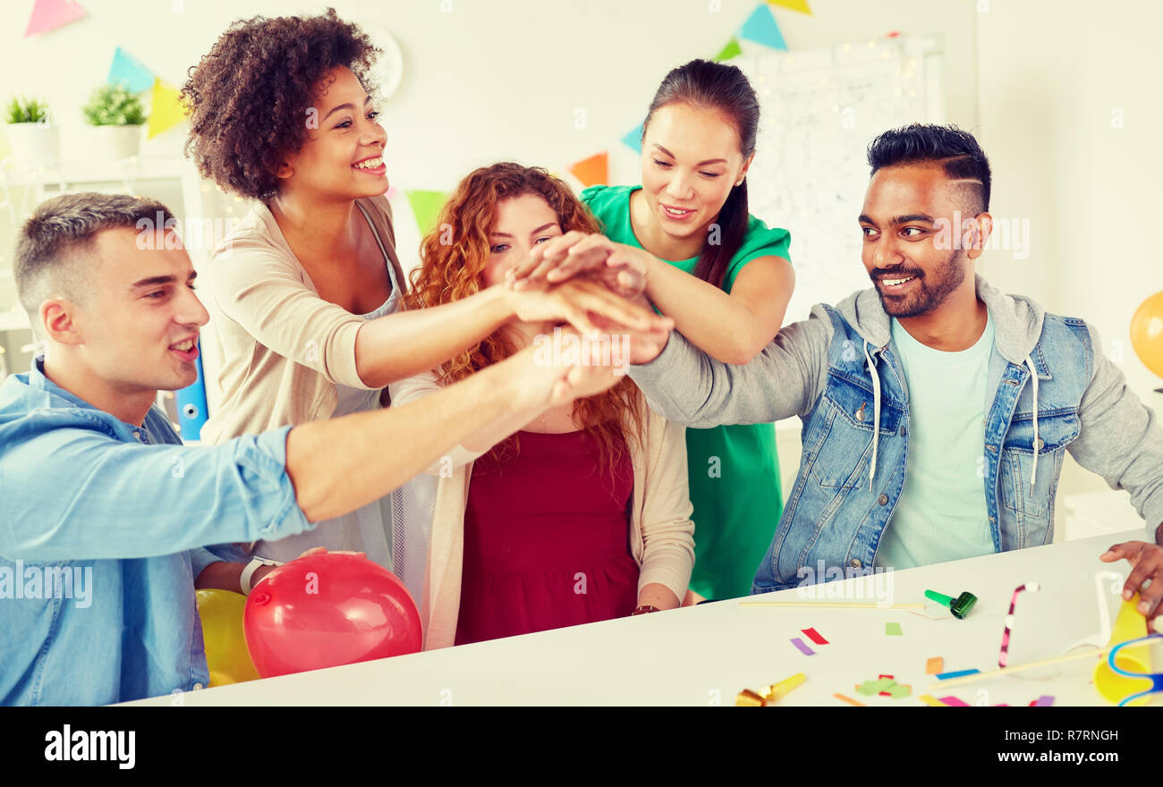 happy business team at office party holding hands Stock Photo - Alamy