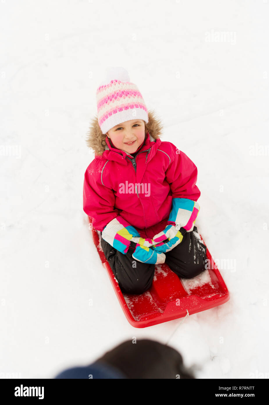 happy little girl on sled outdoors in winter Stock Photo - Alamy