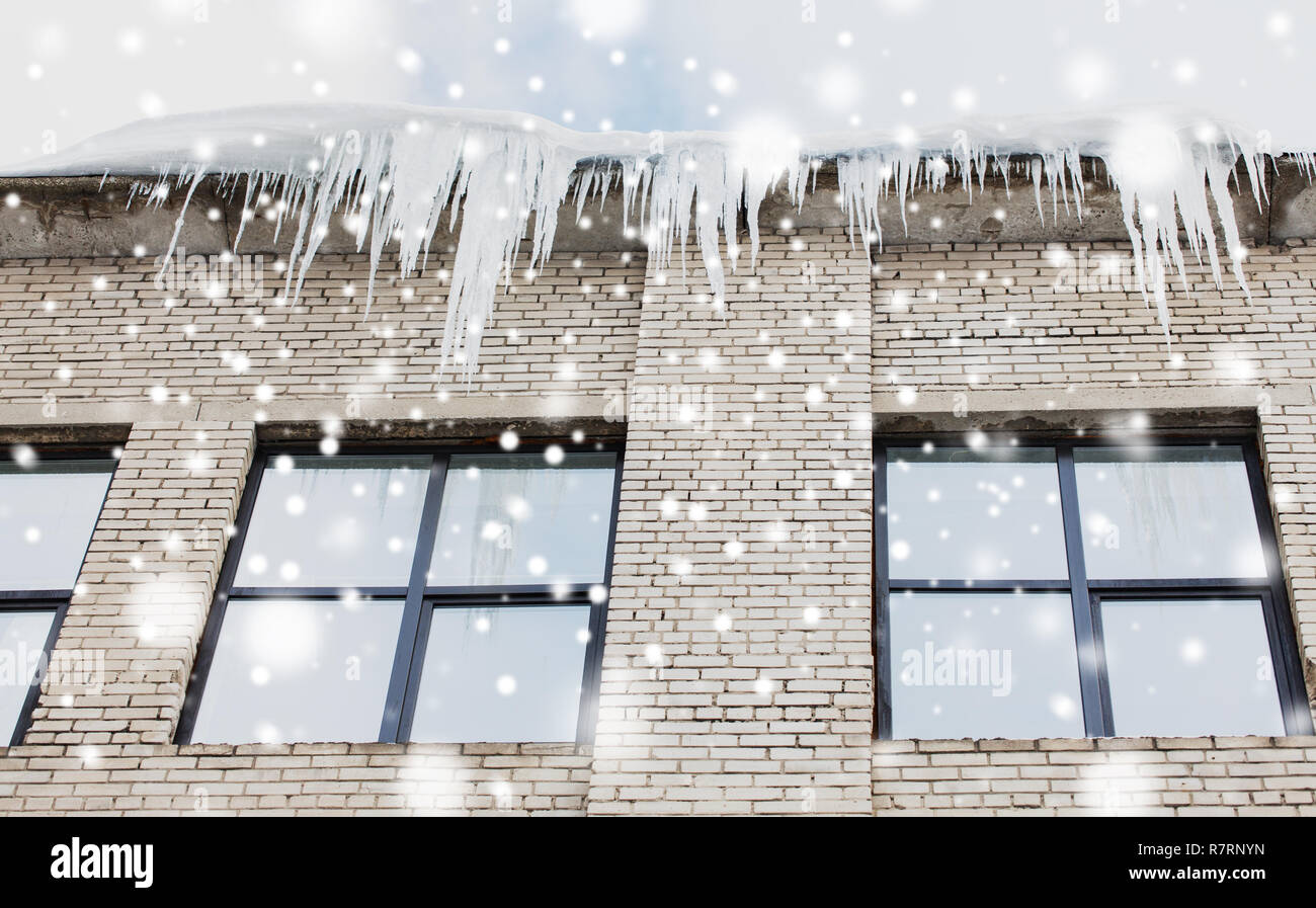 icicles on building or living house facade Stock Photo - Alamy
