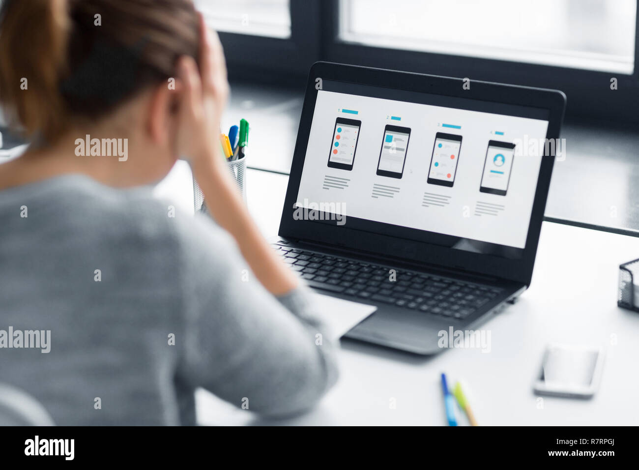 stressed designer with user interface on laptop Stock Photo - Alamy