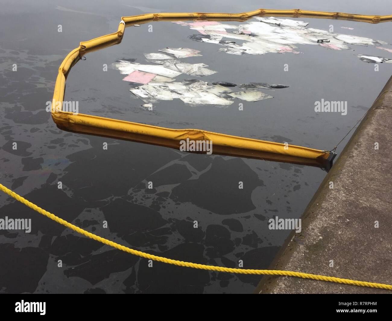 Containment boom sits deployed at the sight of a sunken vessel in the ...