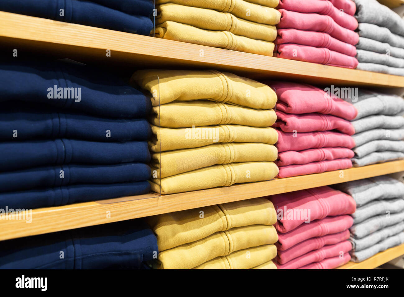 close up of shelves with clothes at clothing store Stock Photo - Alamy