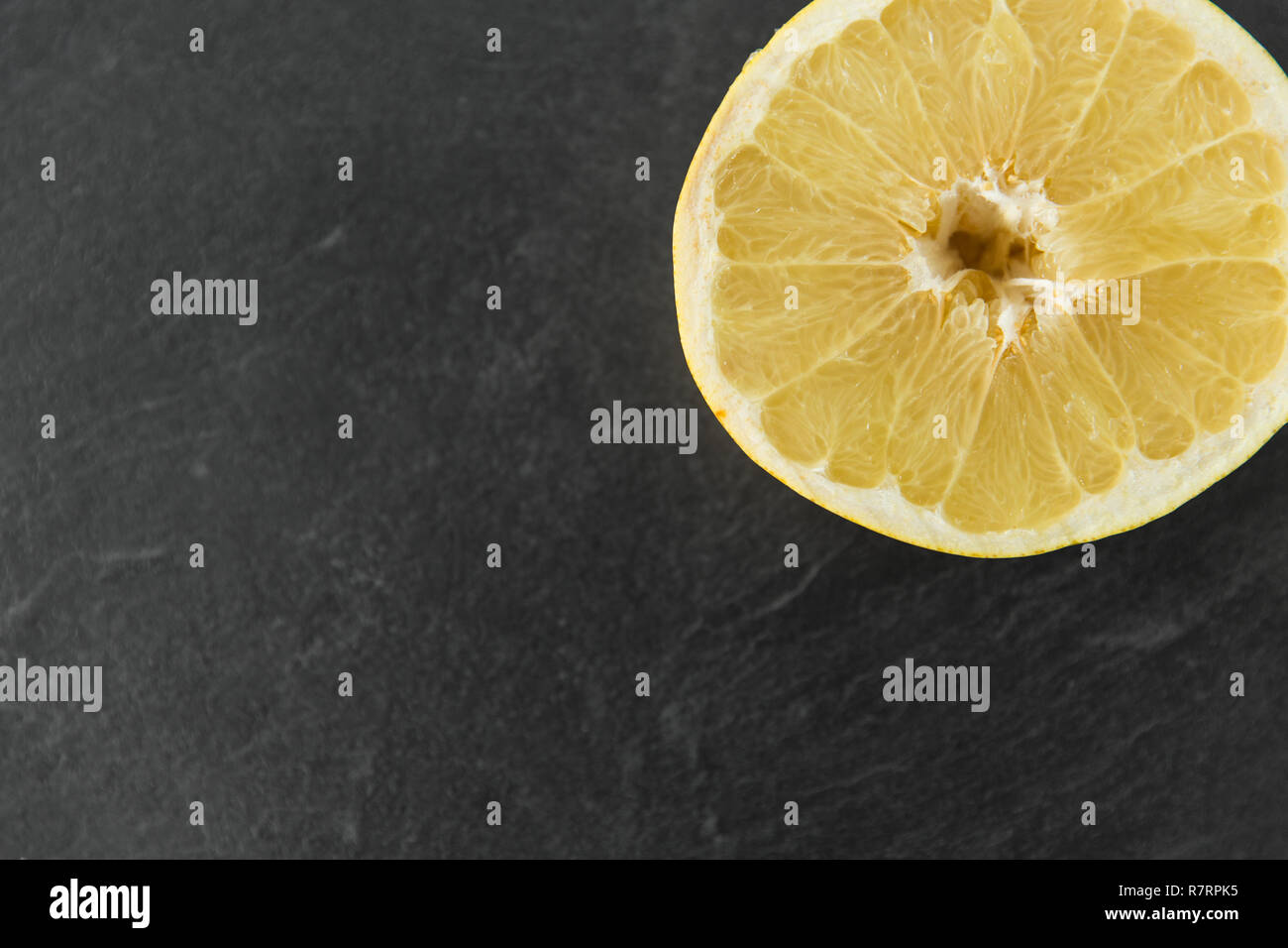 close up of lemon slice on slate table top Stock Photo - Alamy
