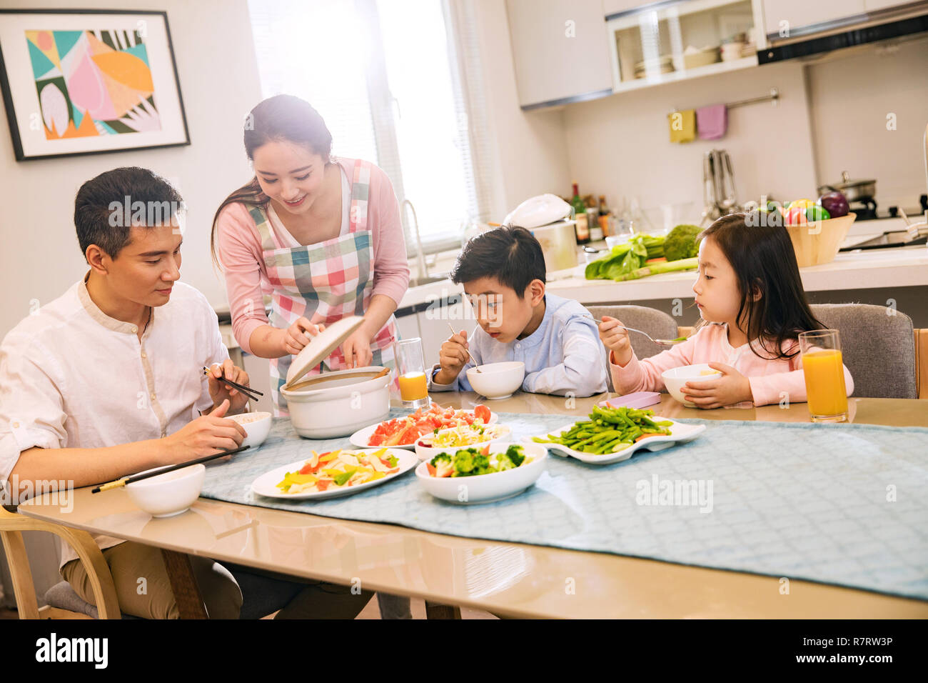 Happy family at dinner Stock Photo - Alamy