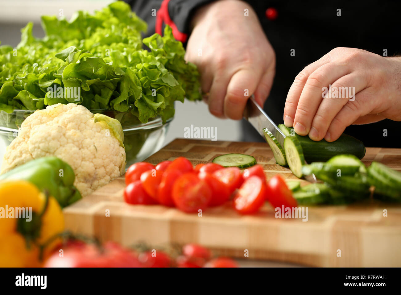 Hand knife cuts cucumber on hi-res stock photography and images - Alamy