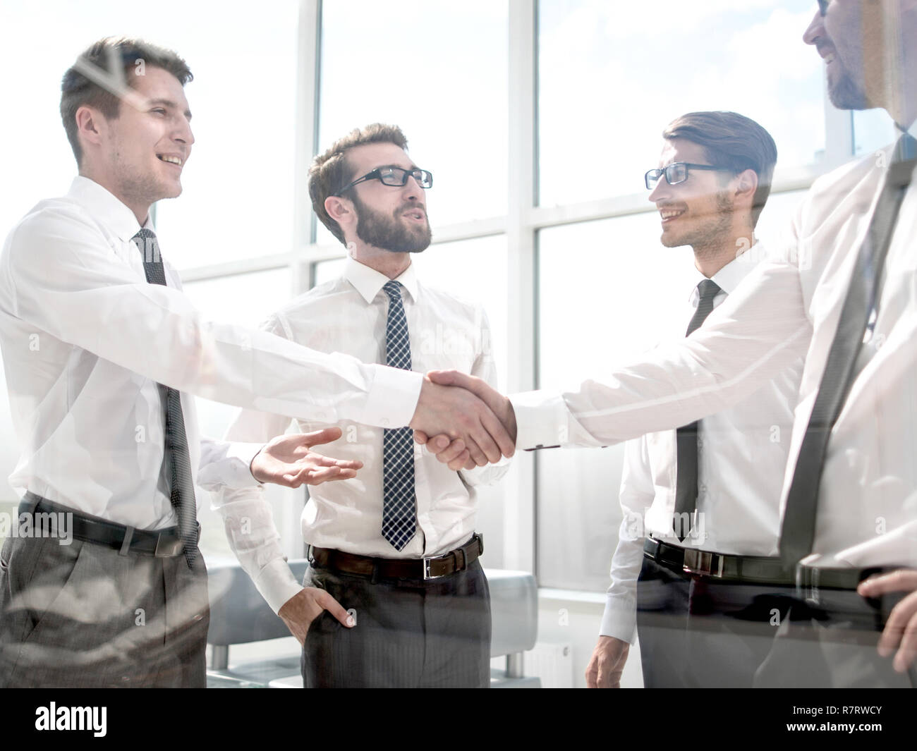 successful employees shaking hands at the workplace in the offic Stock ...