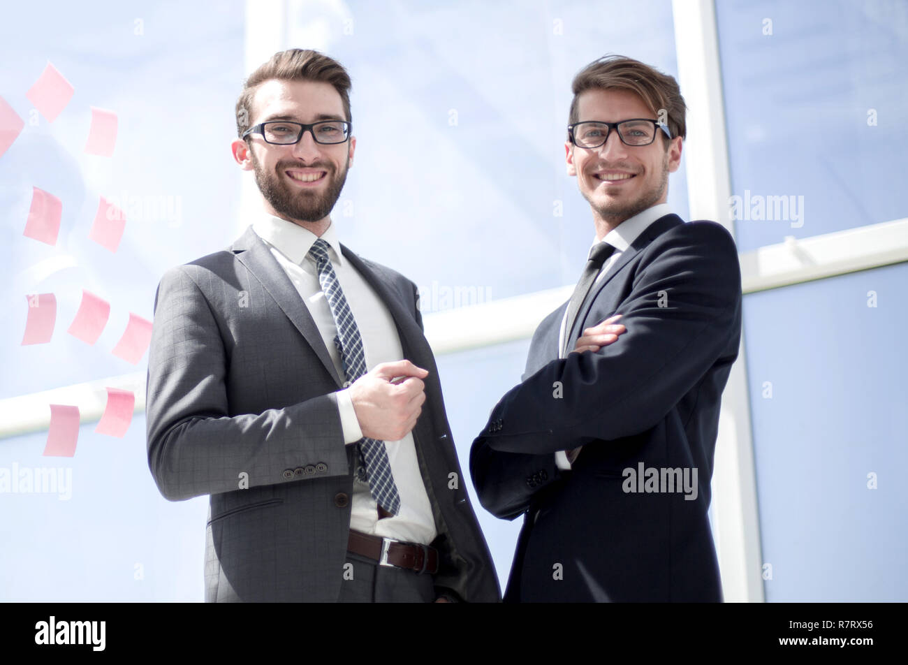 two successful business people standing in the office Stock Photo - Alamy