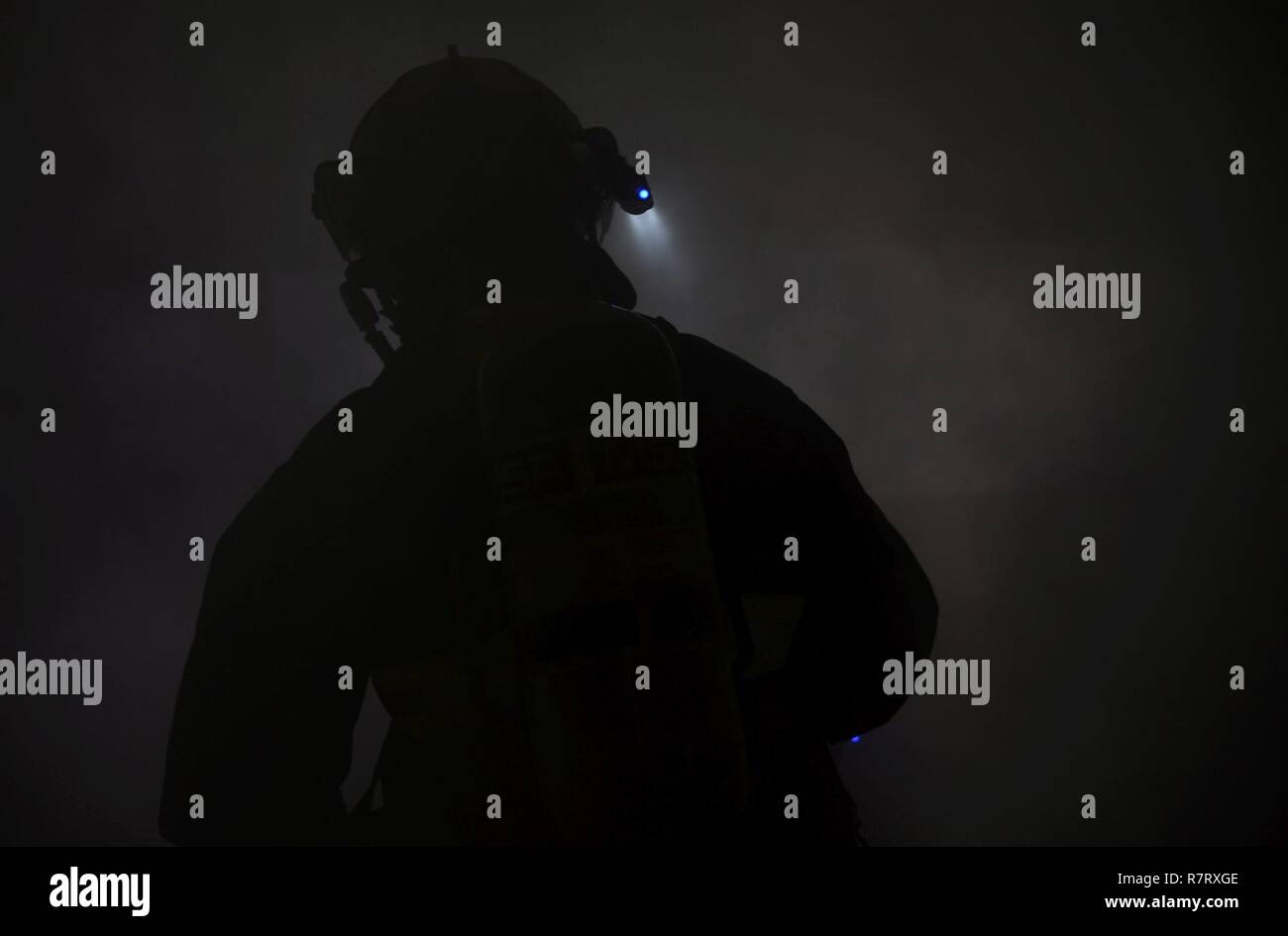 A 22nd Civil Engineer Squadron firefighter walks through smoke during a ...
