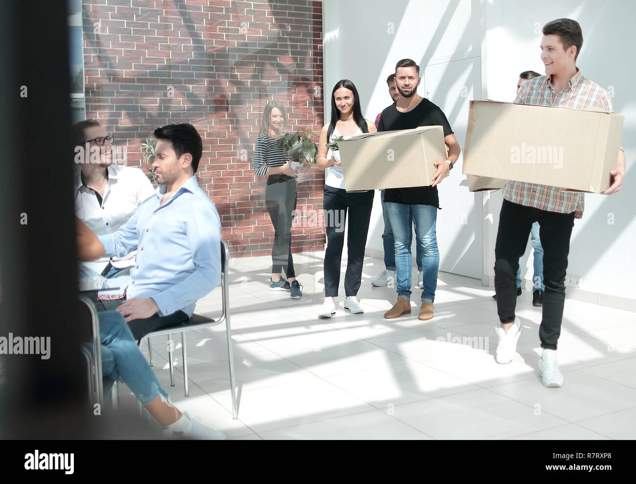 creative business team brings cardboard boxes to the new office Stock ...