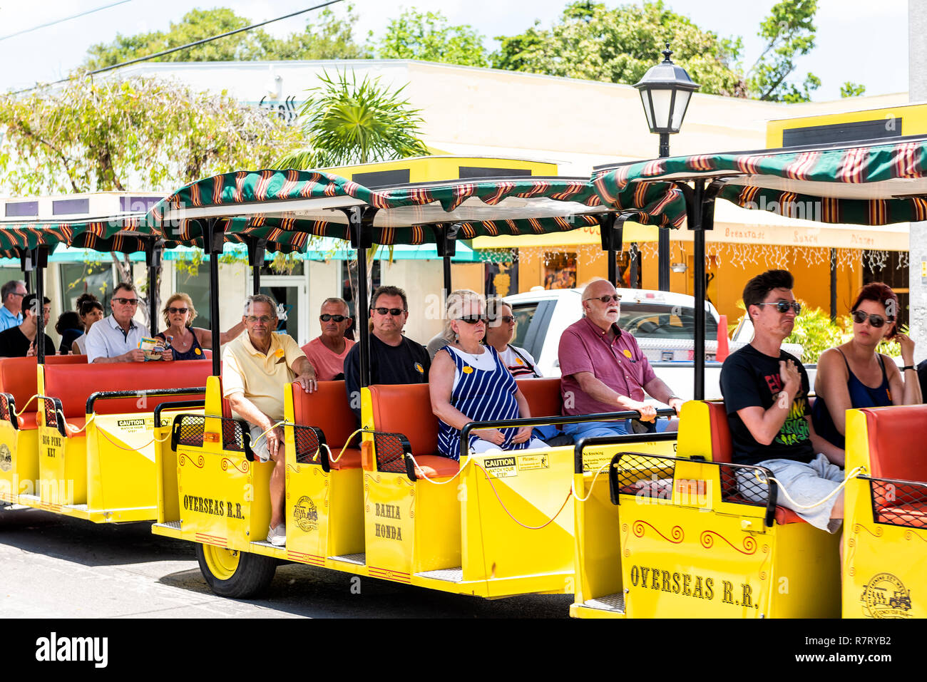 Key West, USA - May 1, 2018: People riding tour bus yellow conch ...