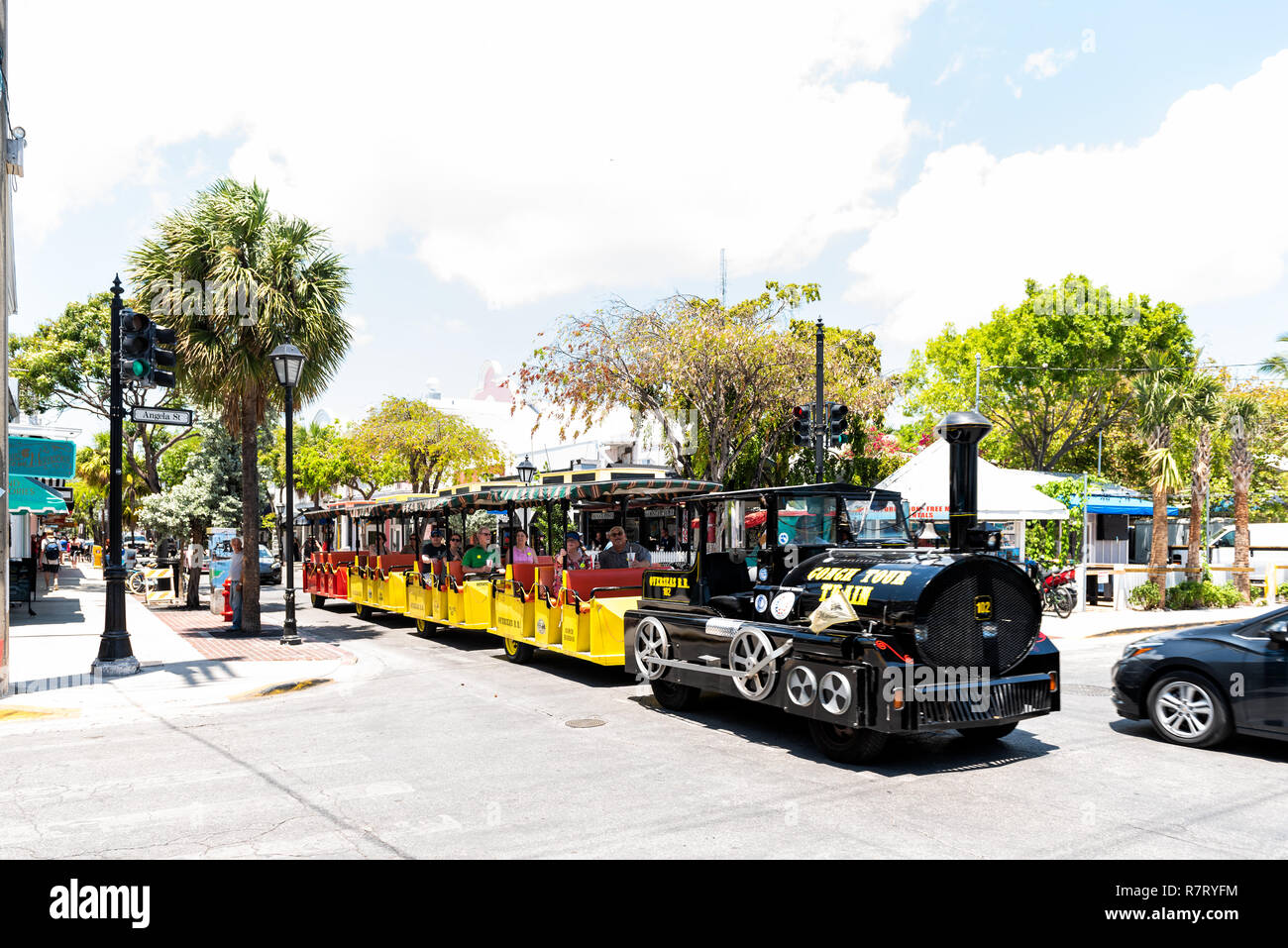 Key West, USA - May 1, 2018: People riding tour bus yellow black conch ...