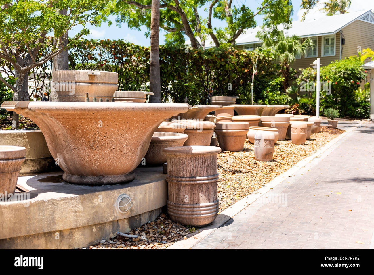 Key West, USA - May 1, 2018: Duval street Pier House many stone flower ...
