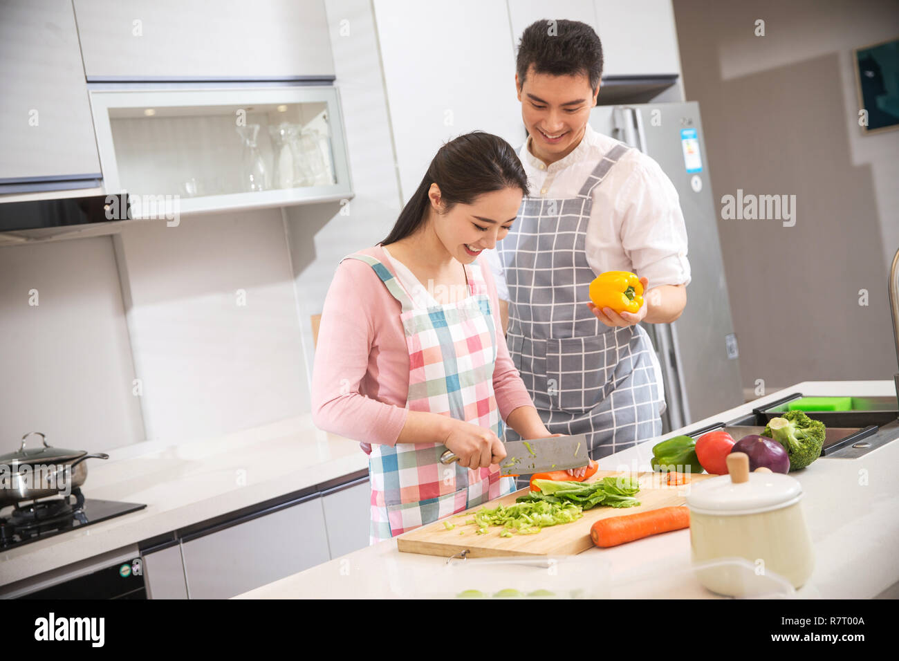 Young couples in the kitchen Stock Photo - Alamy