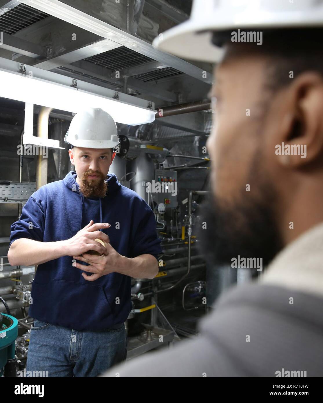 Morris Williams, USNS Trenton first engineer, provides guidance as ...
