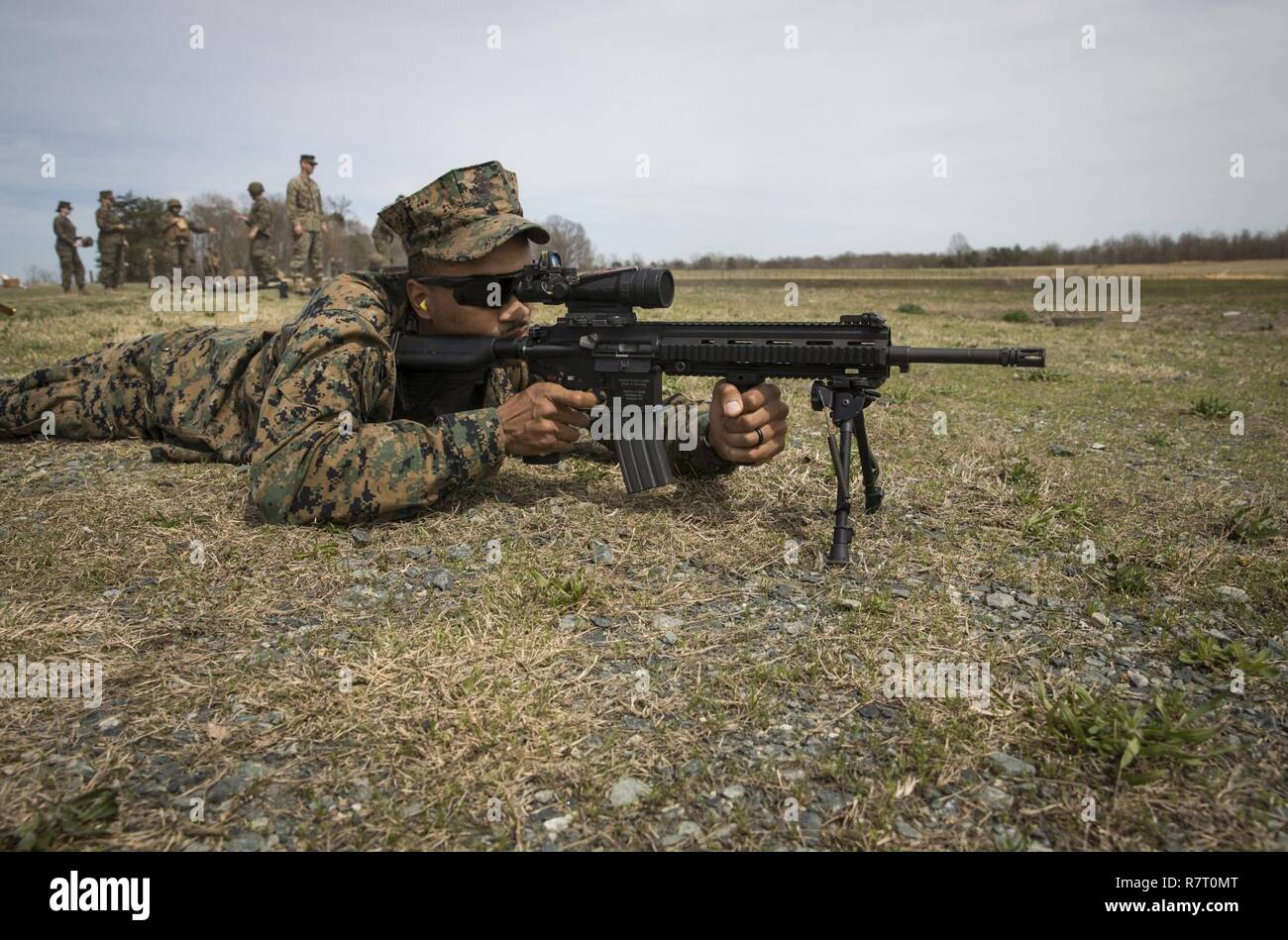 A U.S. Marine with Headquarters and Service Battalion fires the M27 ...