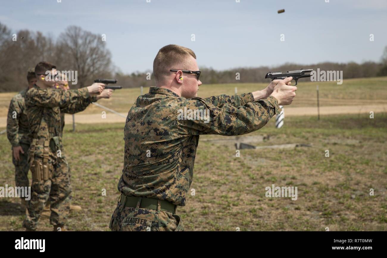 A U.S. Marine with Headquarters and Service Battalion fires the Beretta ...