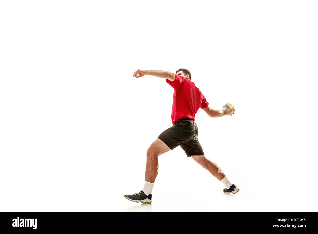 The fit caucasian young male handball player at studio on white ...