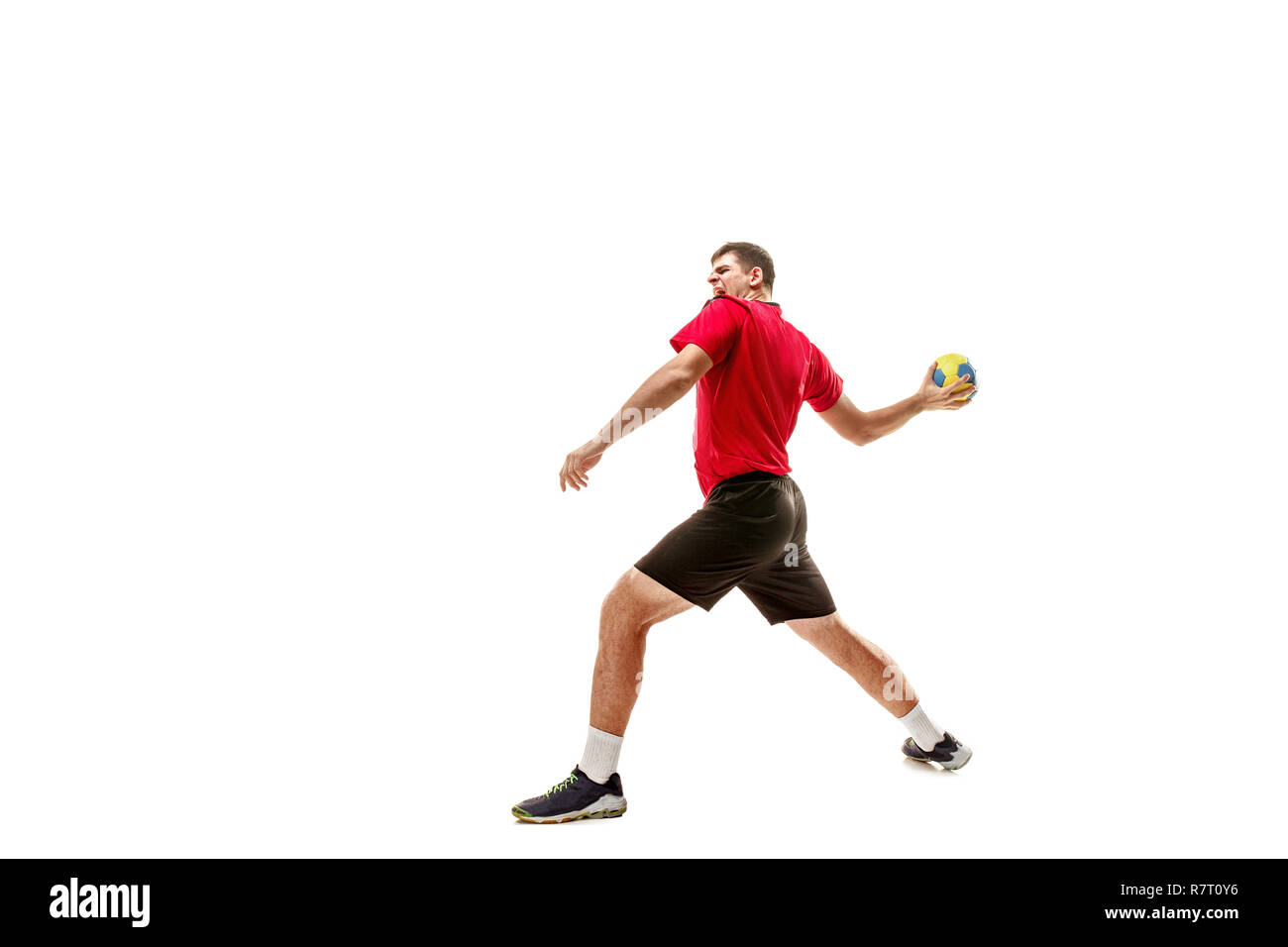The fit caucasian young male handball player at studio on white ...