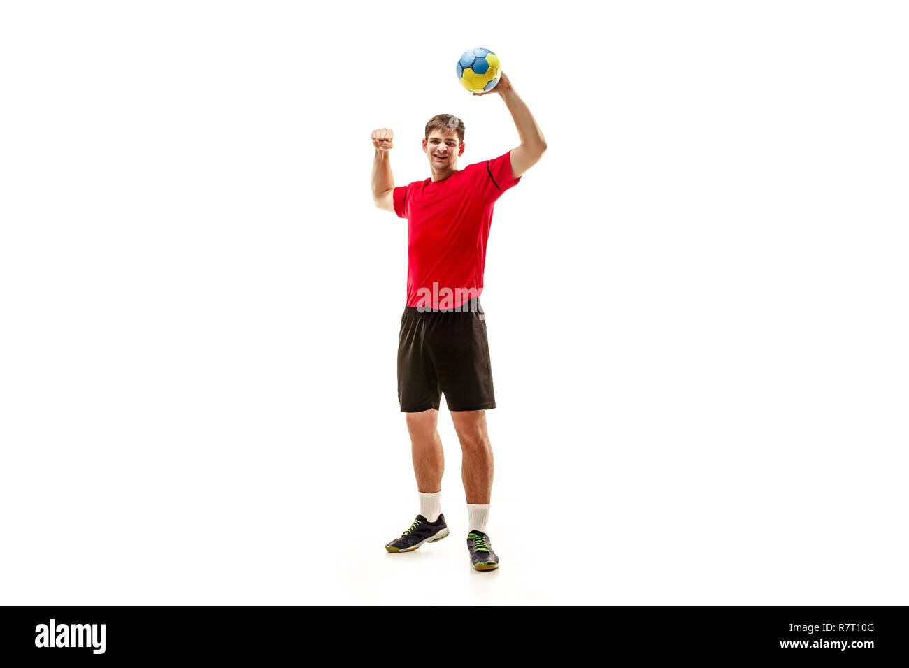 The happy fit caucasian young male handball player at studio on white ...