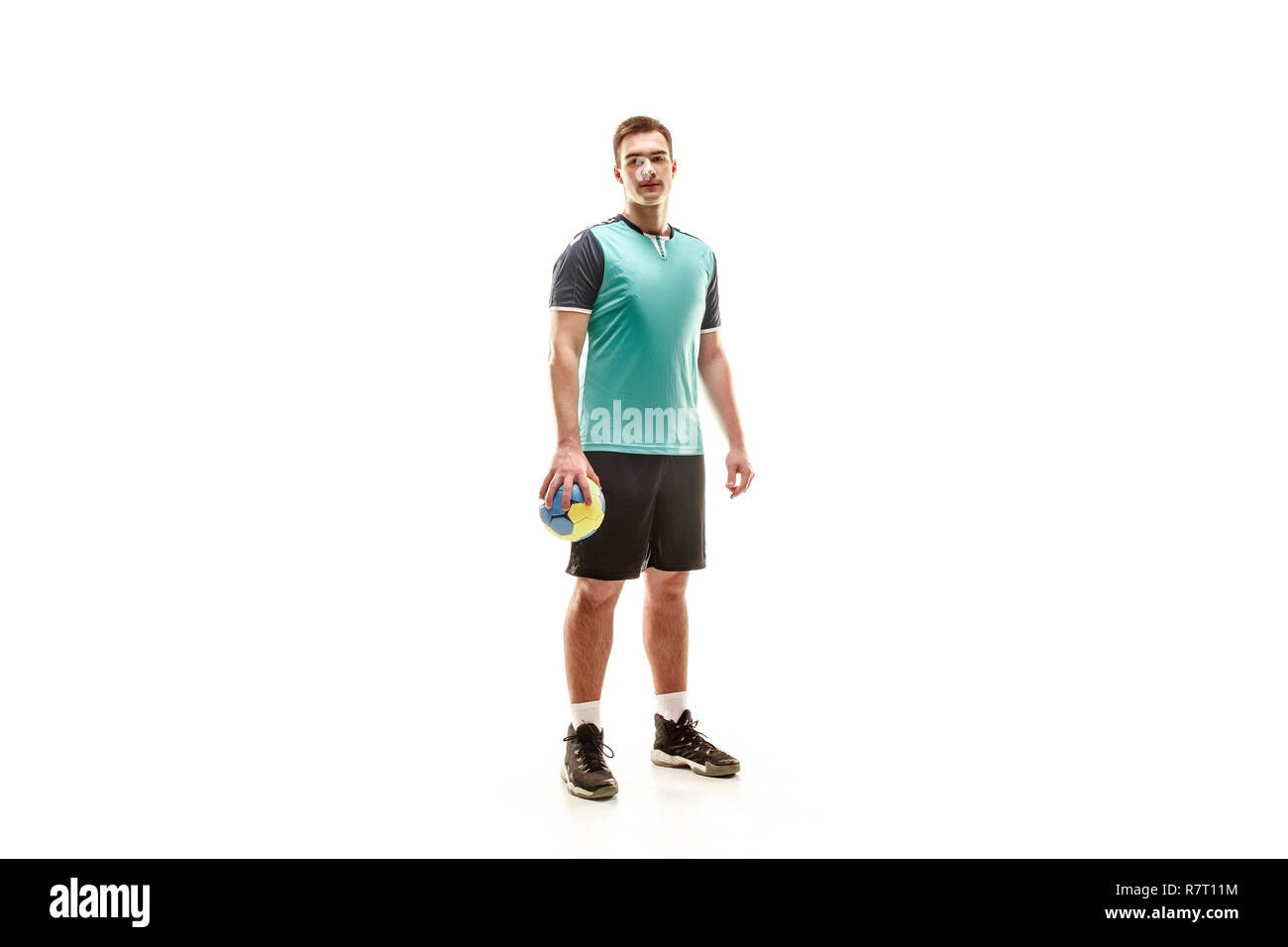 The fit caucasian young male handball player at studio on white ...