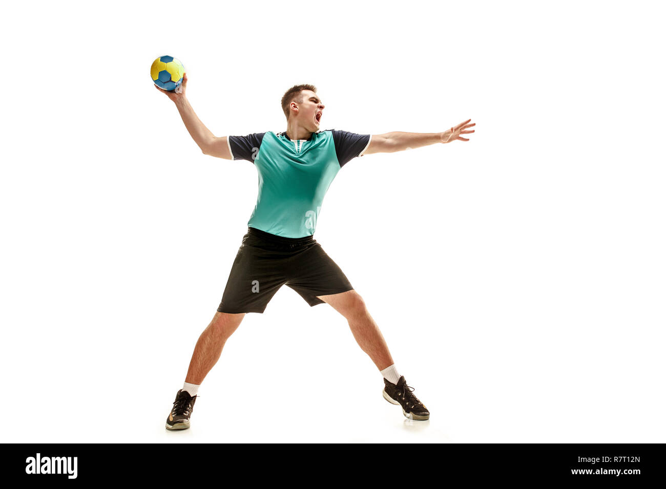 The fit caucasian young male handball player at studio on white ...