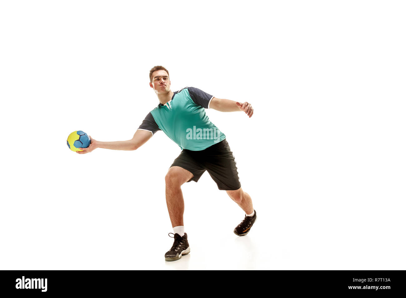 The fit caucasian young male handball player at studio on white ...