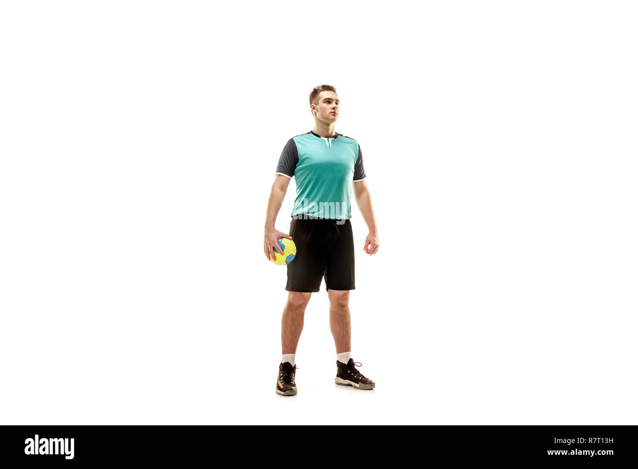 The fit caucasian young male handball player at studio on white ...