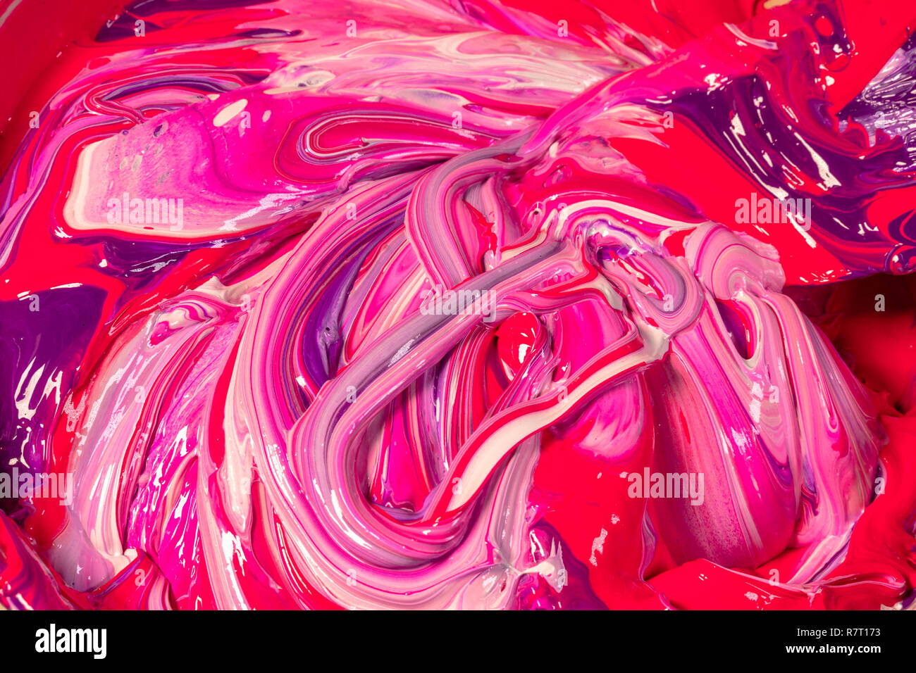 mixing a new light pink color by put white color pink color and purple ...