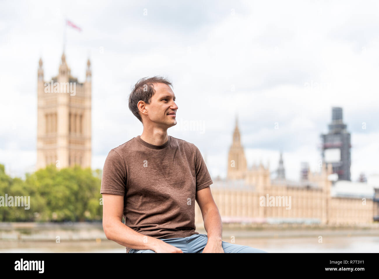 London, UK happy smiling man face sitting, cityscape skyline of city ...