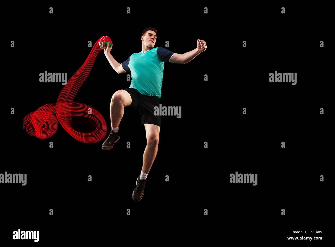 The fit caucasian young male handball player at studio on black ...