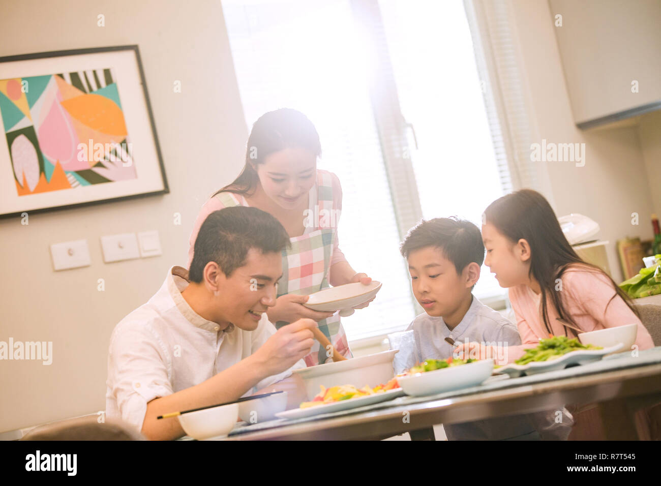 Happy family at dinner Stock Photo - Alamy