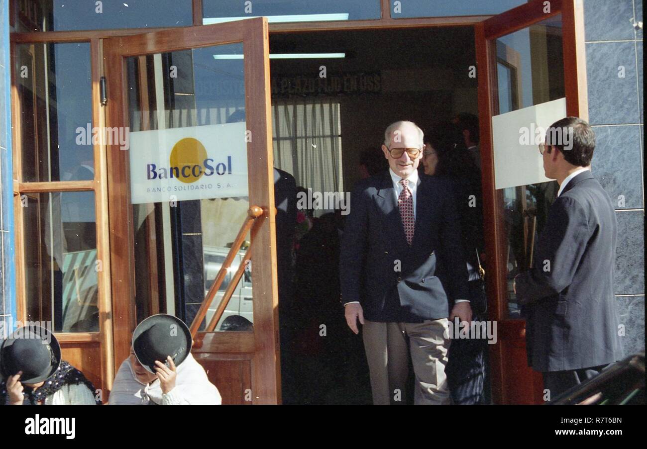 man walking out of building BancoSol Stock Photo - Alamy