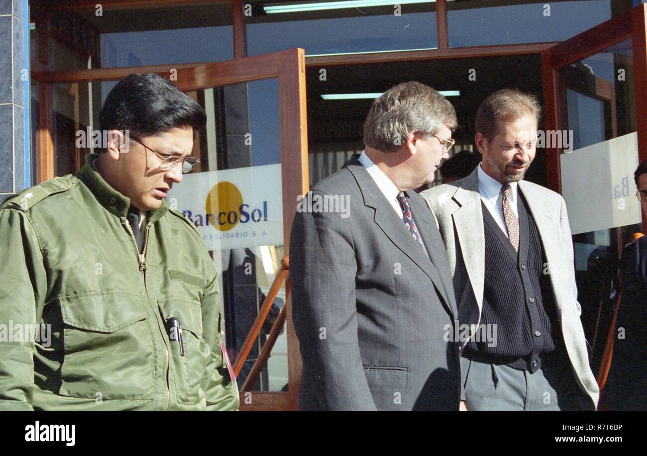men walking out of building BancoSol Stock Photo - Alamy