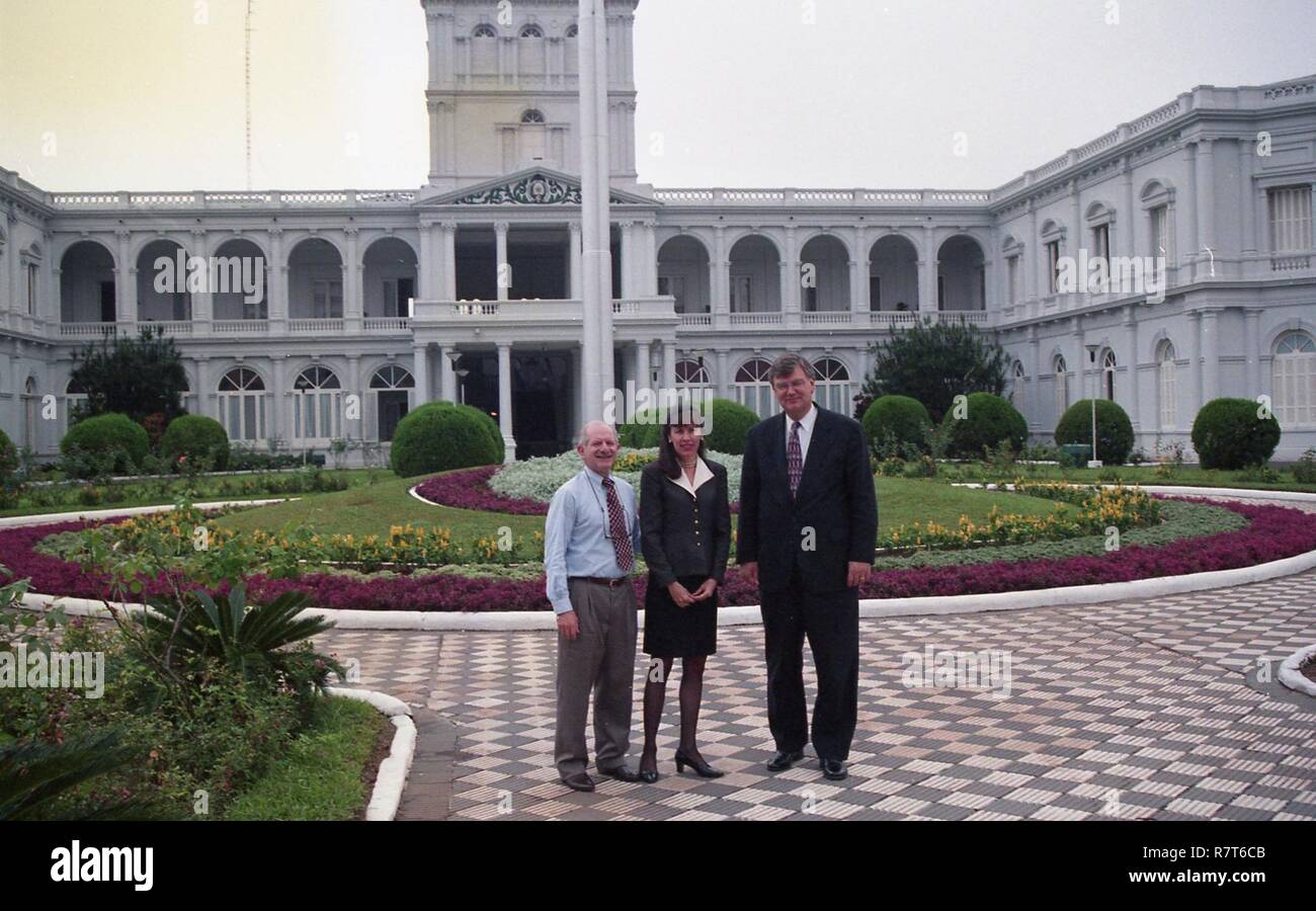 men and woman infront of white building Stock Photo - Alamy