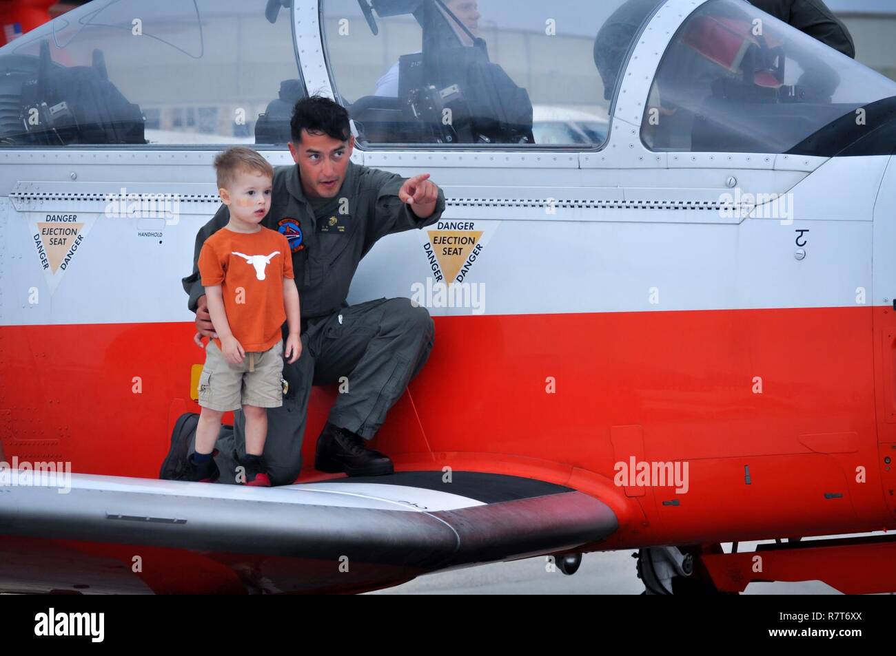 U.S. Marine Corps 2nd Lt. Billy Cooper, VT-27, helps a young spectator ...