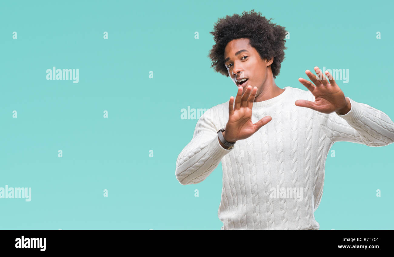 Afro american man over isolated background afraid and terrified with ...
