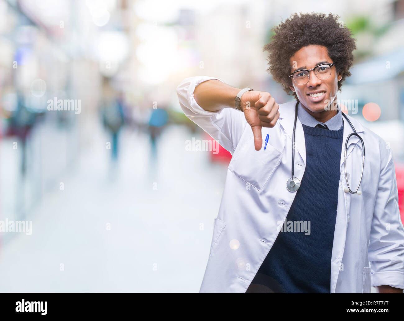 Afro american doctor man over isolated background looking unhappy and ...