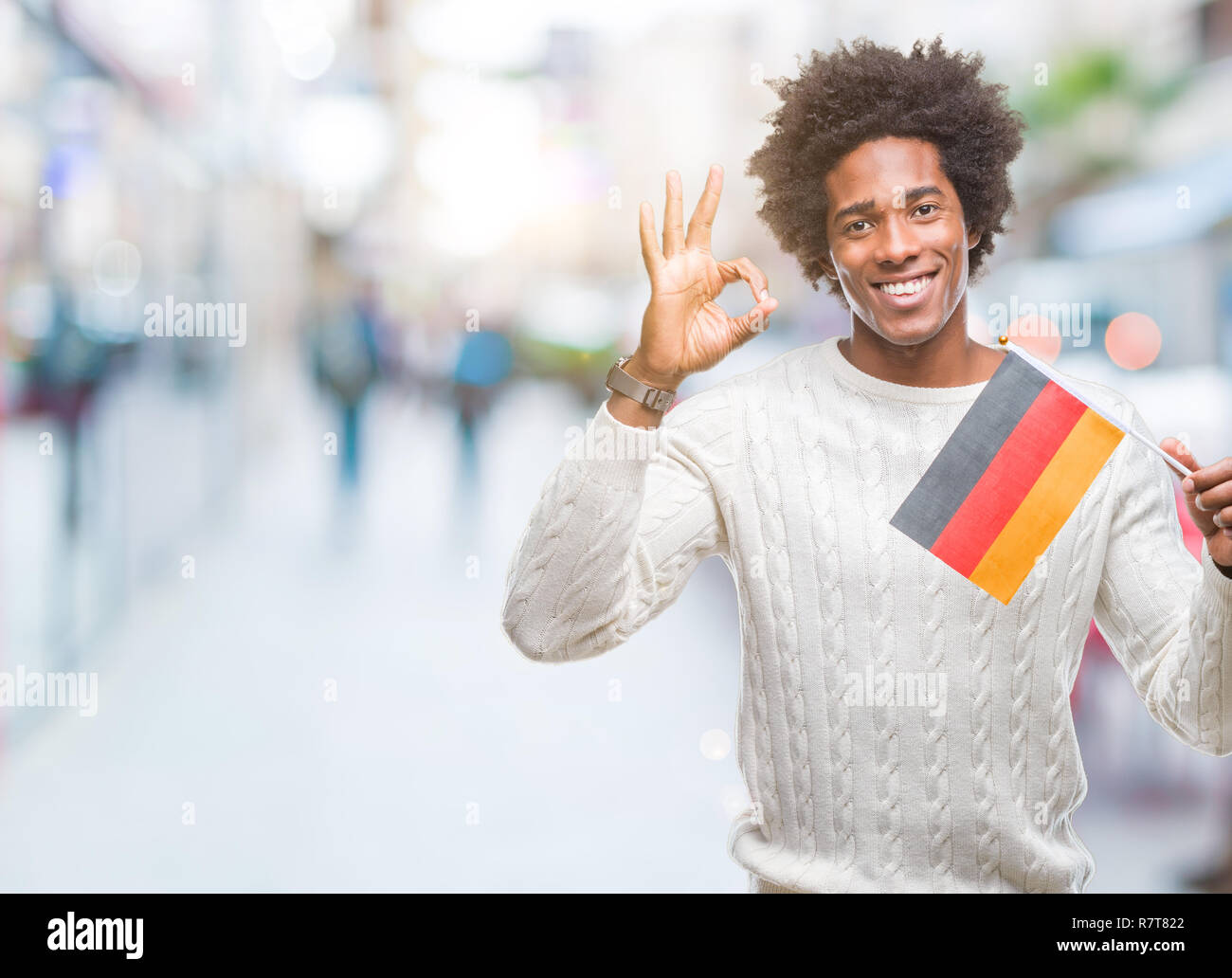 Afro american man flag of Germany over isolated background doing ok ...