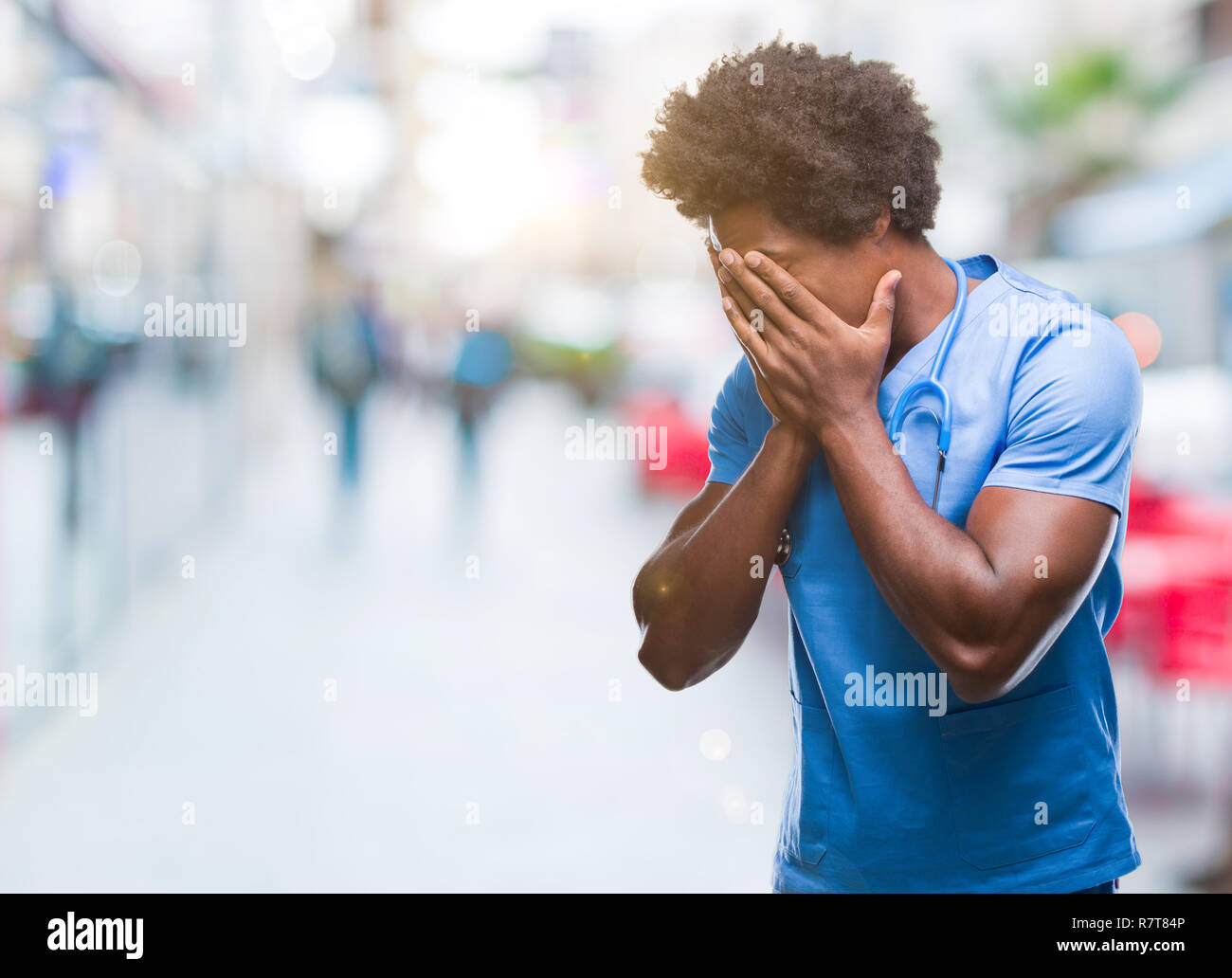Afro american surgeon doctor man over isolated background with sad ...