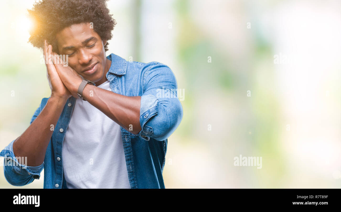 Afro american man over isolated background sleeping tired dreaming and ...